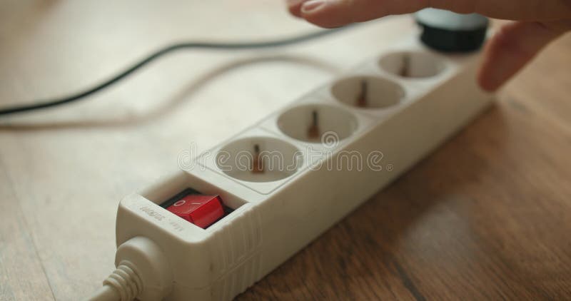 Unplugging an Electrical Power Cord from a Wall Socket in the Office ...