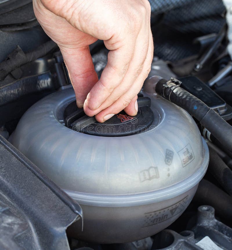 A Man Unscrews the Expansion Tank Cap of a Car with Coolant, Close-up ...