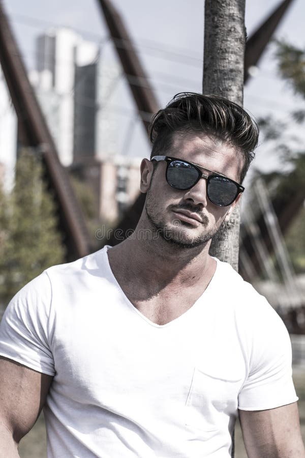 Man in Urban Setting in Front of Big Metal Structure Stock Photo ...