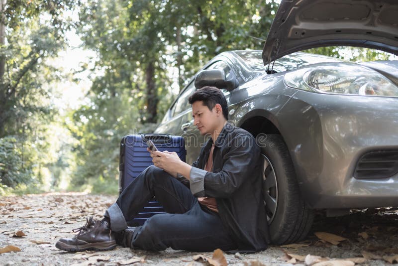 Man Use a Cellphone Call Garage beside Open Hood of a Broken Car on the ...