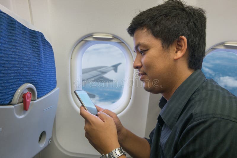 Man Use Smart Phone in Airplane Stock Image - Image of flight, plane ...