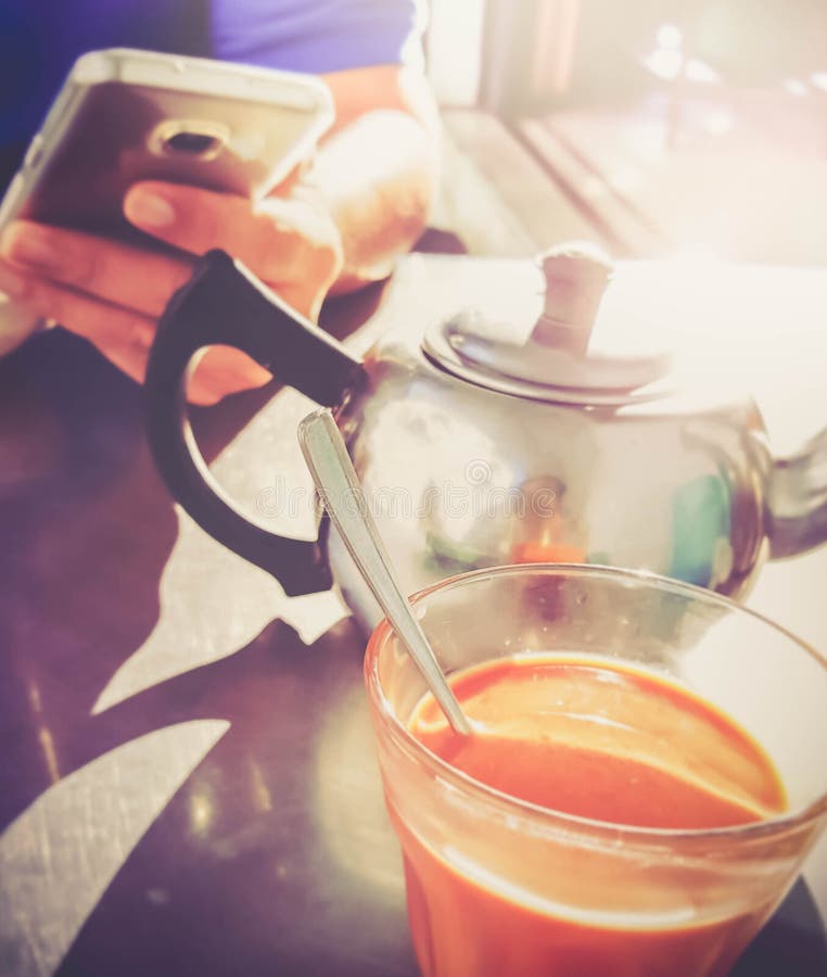 Man Use Smart Phone and a Cup of Milk Tea and Pot Stock Image - Image ...