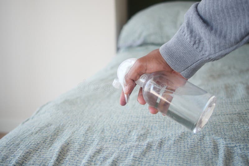Man Use Spray for Clean the Bed at Home. Stock Photo - Image of spray ...