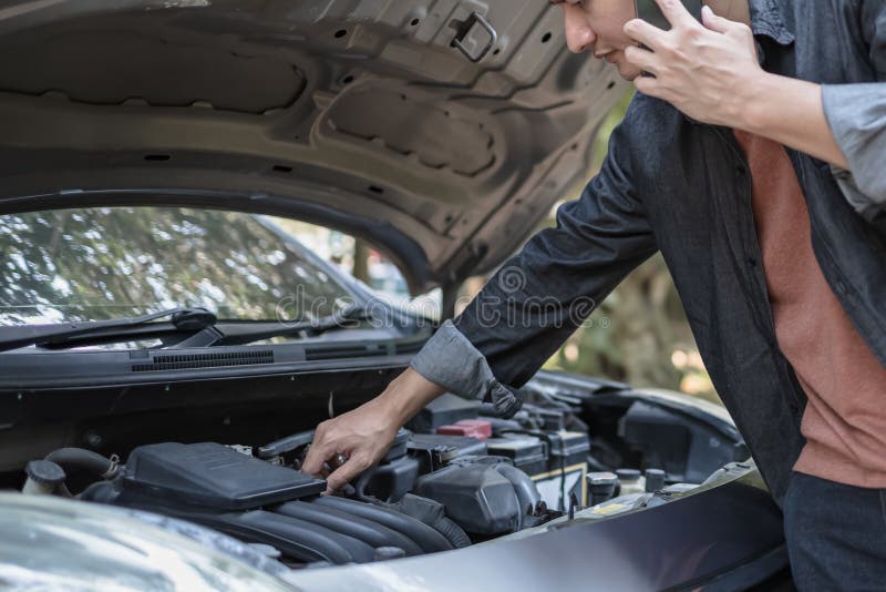 Man Usea Cellphone Call Garage in Front of the Open Hood of a Broken ...