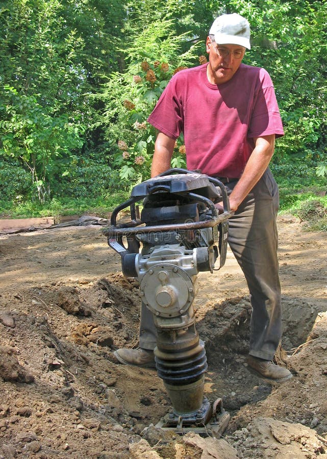 Man uses compactor stock image. Image of machine, action - 6139317