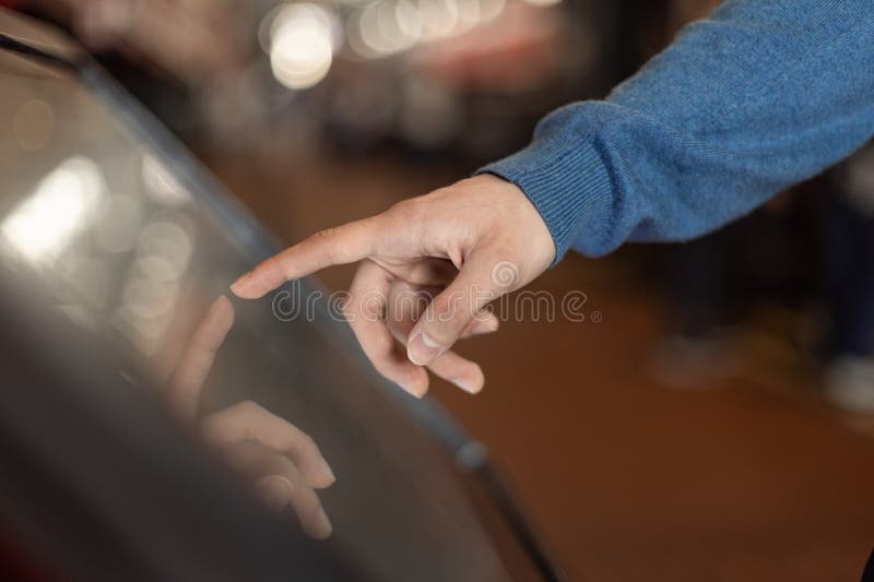 A Man Uses a Digital Terminal with a Touchscreen, an Electronic Queue ...