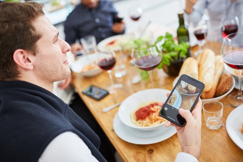 Man Uses Smartphone while Eating with Friends Stock Photo - Image of ...