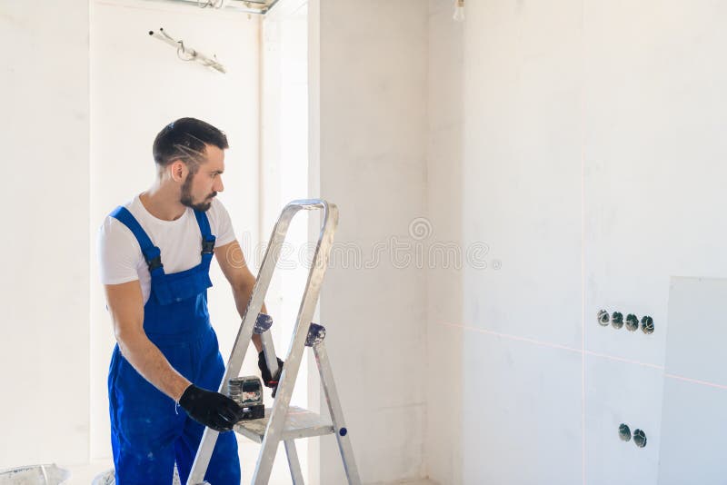 The Man Uses a Stepladder and a Laser Level Stock Photo - Image of ...