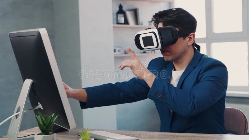 Man Uses Virtual Realitiy Glasses and Computer. VR Headset in Work ...