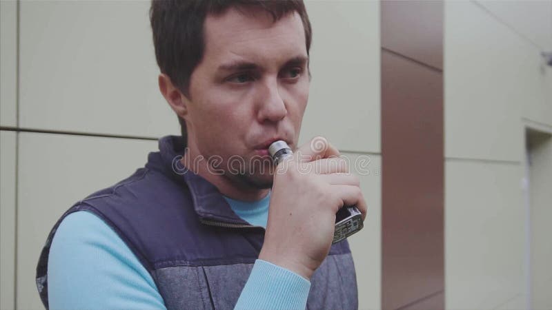 Man Using an Advanced Personal Vaporizer or E-cigarette Slow Motion ...