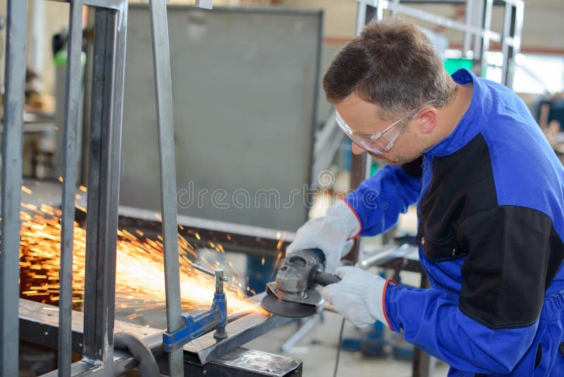 Man using angle grinder stock image. Image of goggles - 121673115