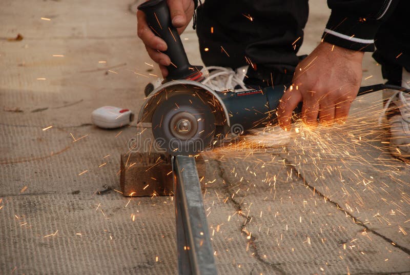 Man using an angle grinder stock photo. Image of grind - 12868026