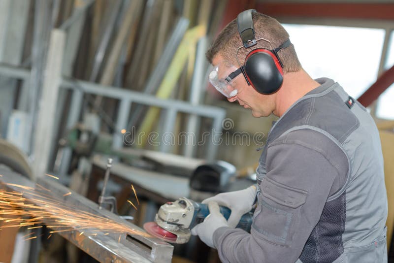 Man using angle grinder stock image. Image of angle - 296369183
