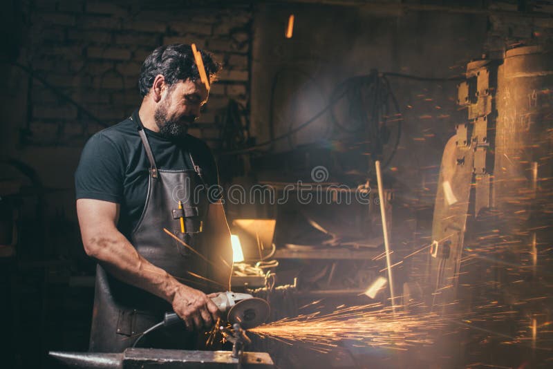 Man Using Angle Grinder in Factory and Throwing Sparks Stock Image ...