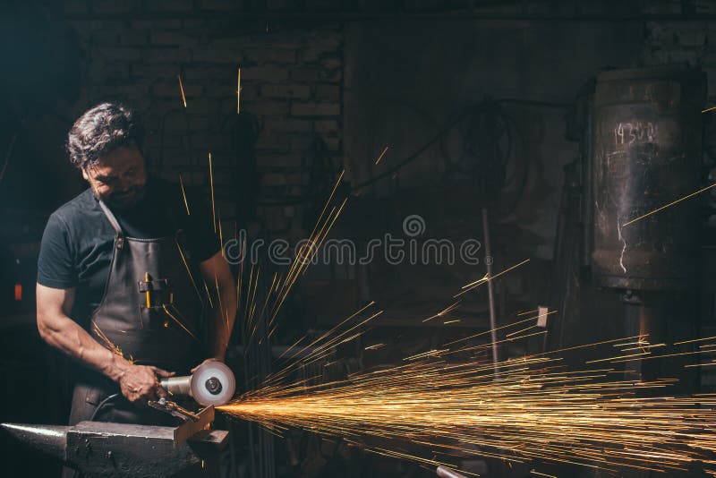 Man Using Angle Grinder in Factory and Throwing Sparks Stock Image ...