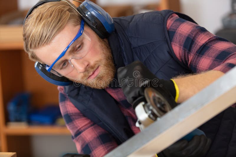 Man Using Angle Grinder on Metal Length Stock Photo - Image of ...