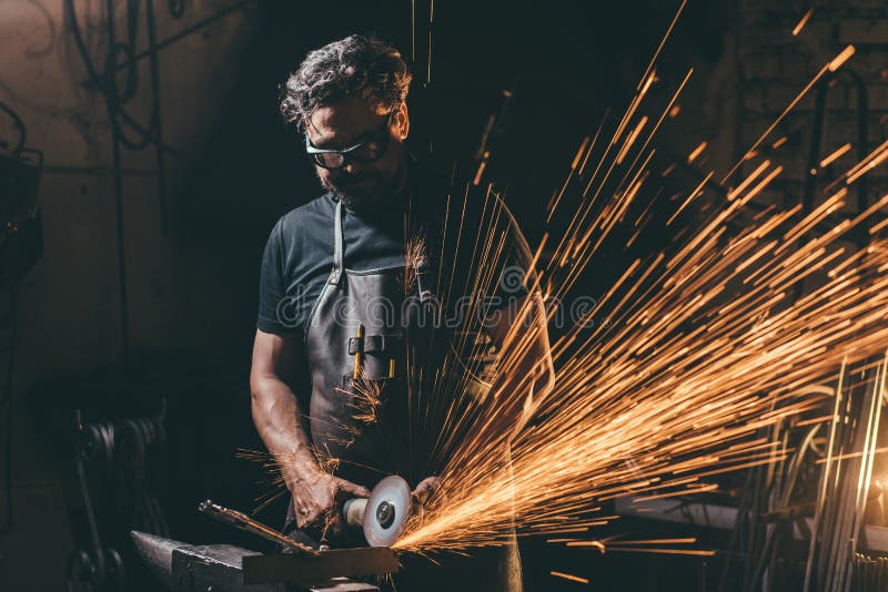 Man Using Angle Grinder in Factory and Throwing Sparks Stock Image ...