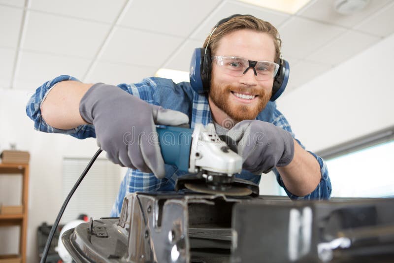 Man Using Angle Grinder in Workshop Stock Photo - Image of portrait ...
