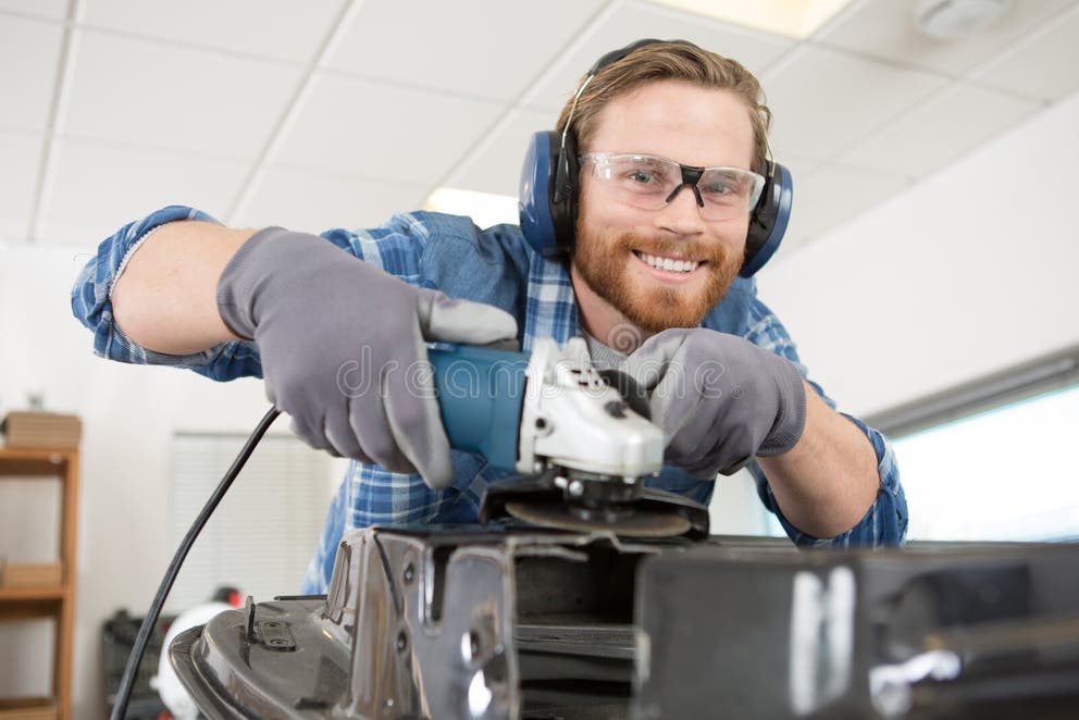 Man Using Angle Grinder in Workshop Stock Photo - Image of portrait ...
