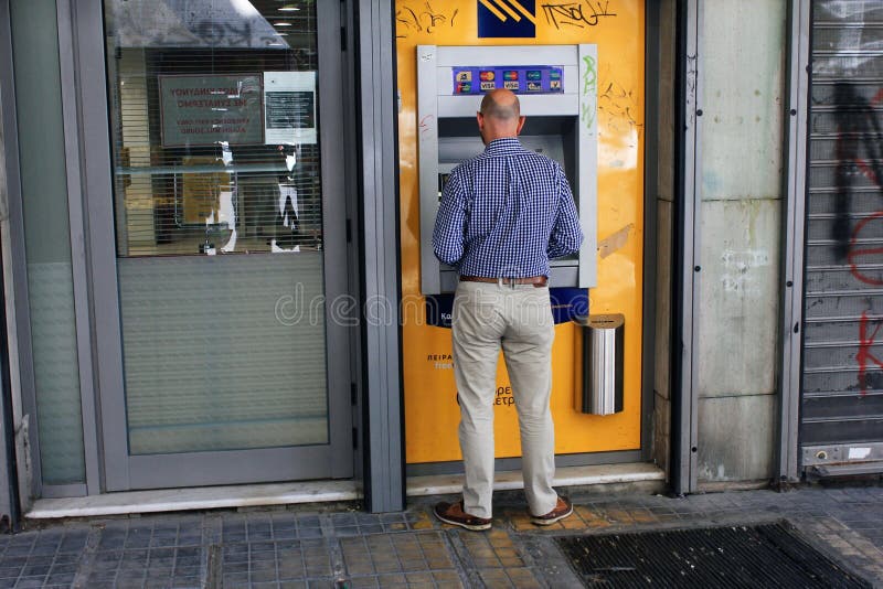 Man Using ATM Machine in the Center of Athens in Greece Editorial ...