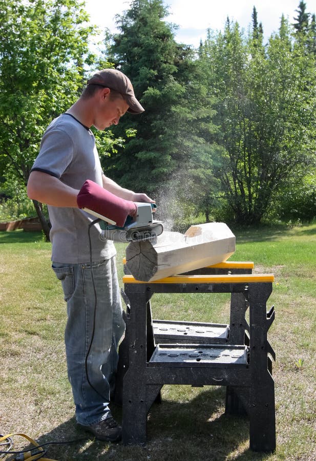 Man Using Belt Sander stock photo. Image of sawdust, sanding - 19863914