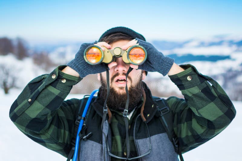 Man Using Binoculars on Snow Covered Mountain Stock Image - Image of ...