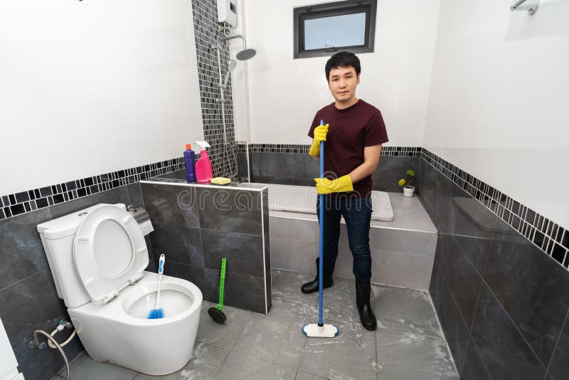 Man Using Brush To Cleaning the Tile in the Bathroom Stock Photo ...