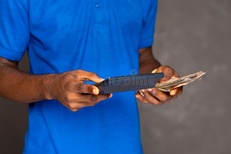 Man Using a Calculator and Holding Some Money Stock Photo - Image of ...