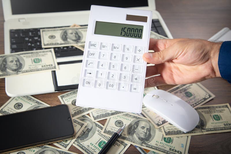 Man Using Calculator with a Money and Computer on the Table Stock Image ...