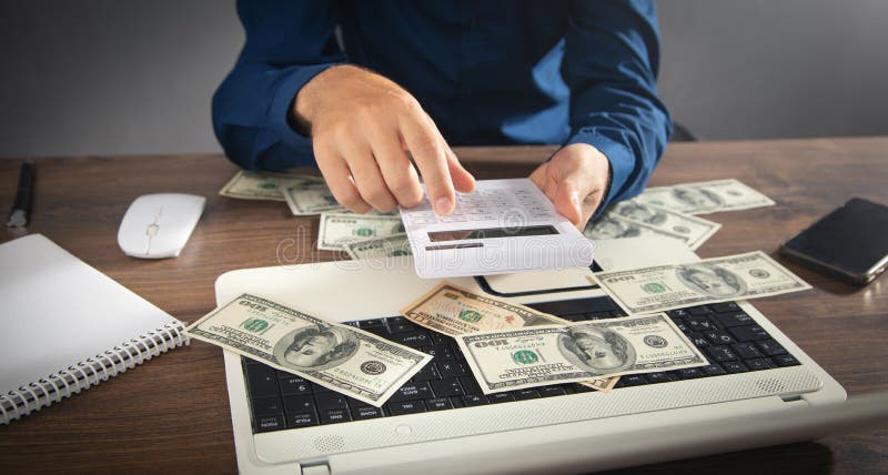 Man Using Calculator with a Money and Computer on the Table Stock Image ...