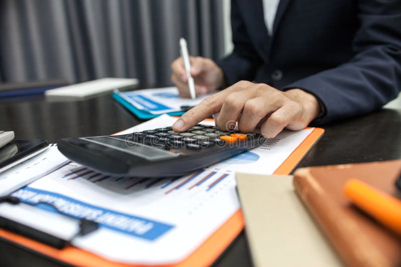 Man Using Calculator and Writing Make Note with Calculate in the Office ...