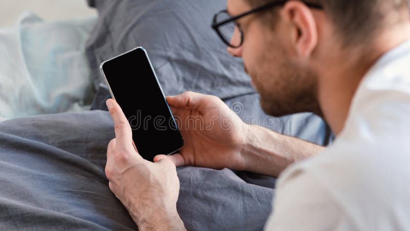 Man Using Cellphone Lying in Bed at Home, Mockup, Panorama Stock Image ...