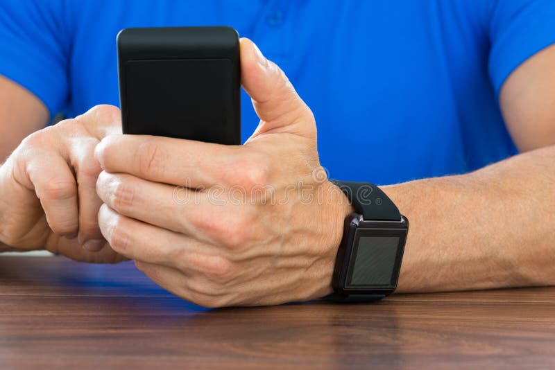 Man Using Cellphone and Wearing Smartwatch Stock Image - Image of ...