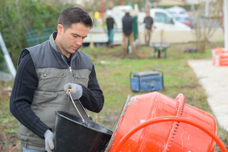 Man using cement mixer stock photo. Image of fabricate - 89314688