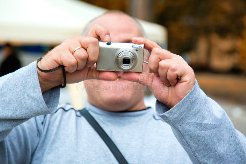 Man using compact camera editorial image. Image of shot - 45610700