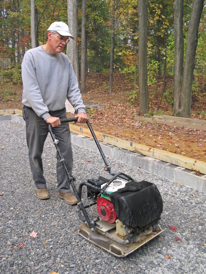 Man Using Compactor To Pack Stone Stock Image - Image of outdoors ...