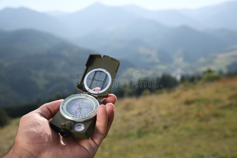 Man Using Compass during Journey in Mountains, Closeup Stock Photo ...