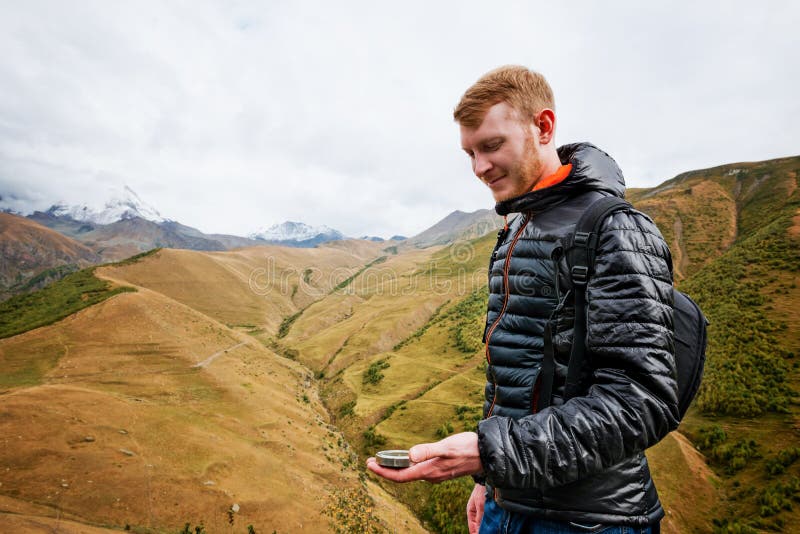 Man using a compass stock photo. Image of tourism, mountains - 129528522