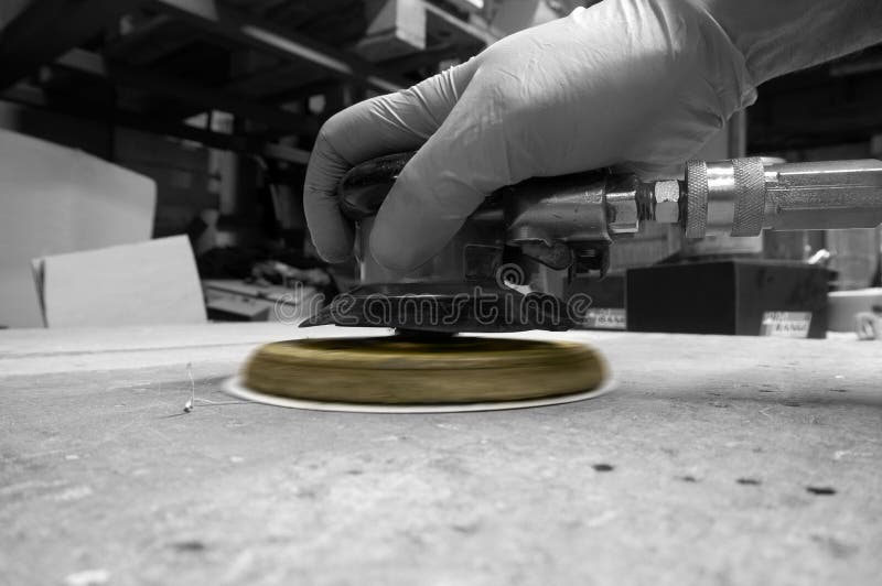 Orbital Air Sander with a Sanding Disc Attached on a Metal Panel Stock ...