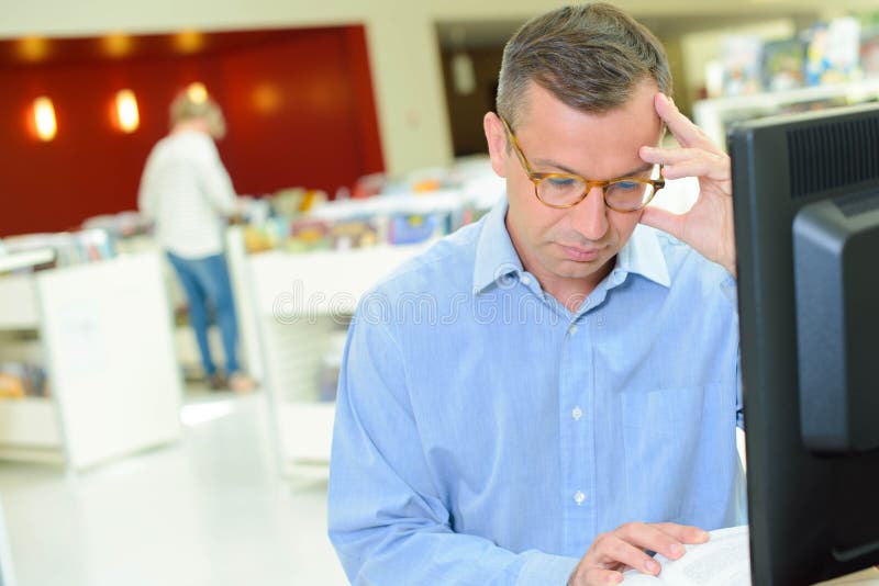 Man Using Computer in Library Stock Photo - Image of indoors, caucasian ...