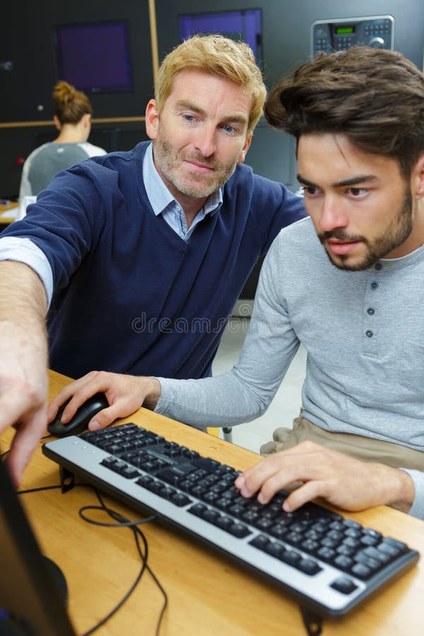 Man Using Computer with Teacher Guidance Stock Photo - Image of ...