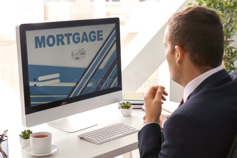 Man Using Computer To Pay Mortgage Loan Online in Office Stock Photo ...