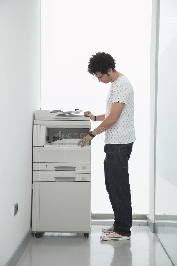 Man Using Copy Machine in Hallway Stock Photo - Image of malaga ...