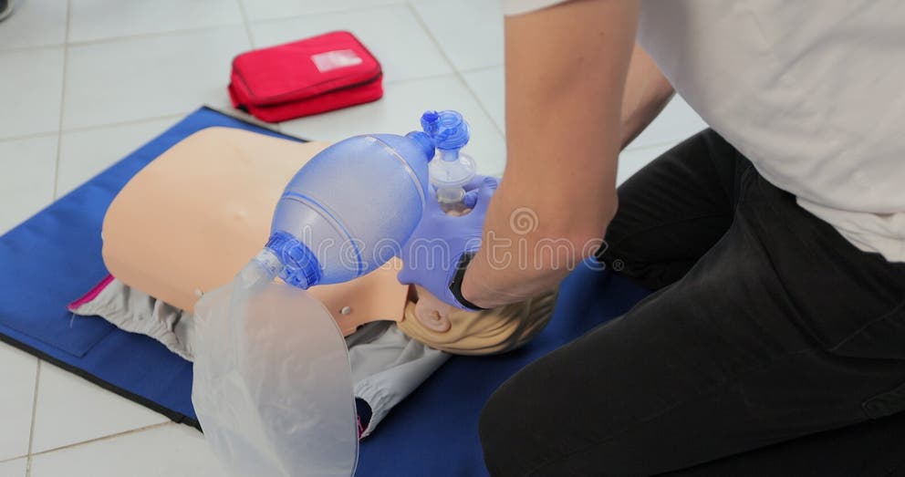 Man Using CPR Technique on Dummy in First Aid Class. Oxigen Mask on ...