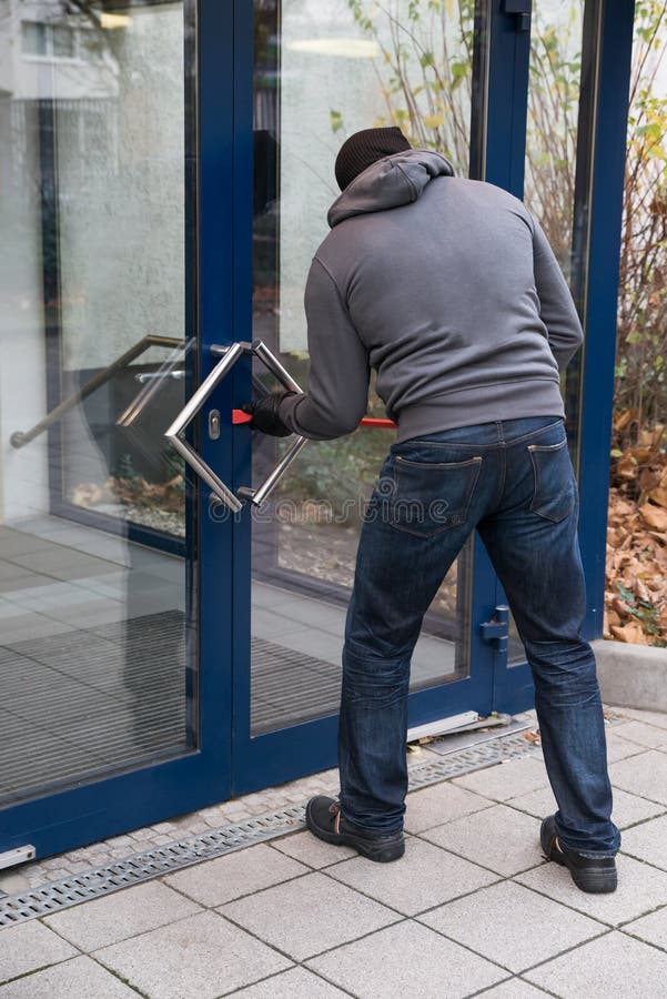 Burglar Using Crowbar To Open Glass Door Stock Photos - Free & Royalty ...