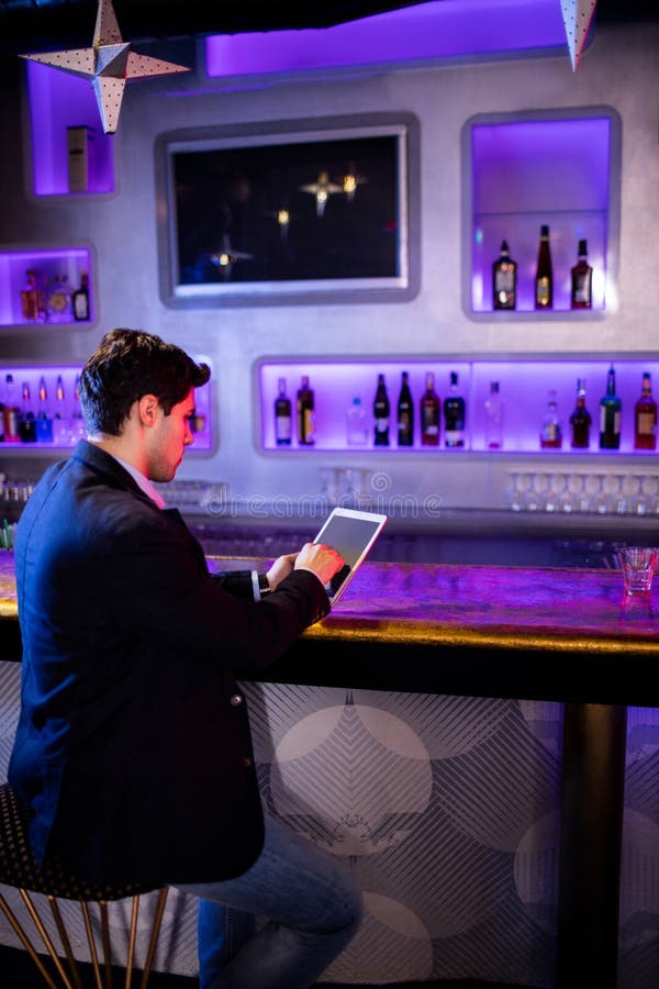 Man Using Digital Tablet at Bar Counter Stock Image - Image of internet ...