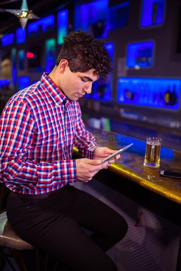 Man Using Digital Tablet at Bar Counter Stock Photo - Image of ...