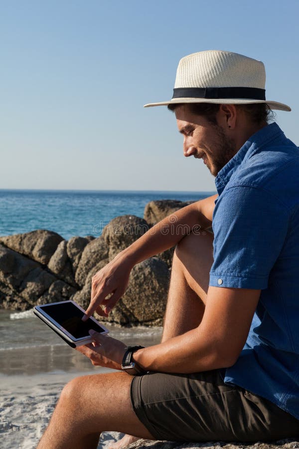 Man Using Digital Tablet on the Beach Stock Photo - Image of reading ...