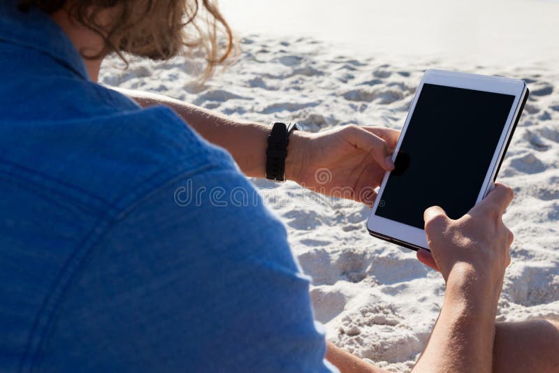 Man Using Digital Tablet on the Beach Stock Photo - Image of reading ...