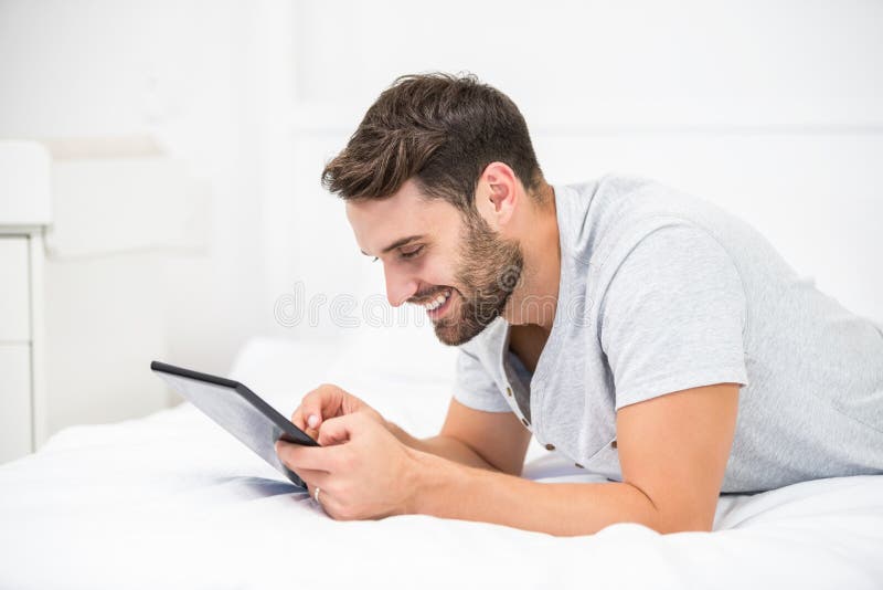 Man Using Digital Tablet on Bed Stock Image - Image of clothing, abode ...
